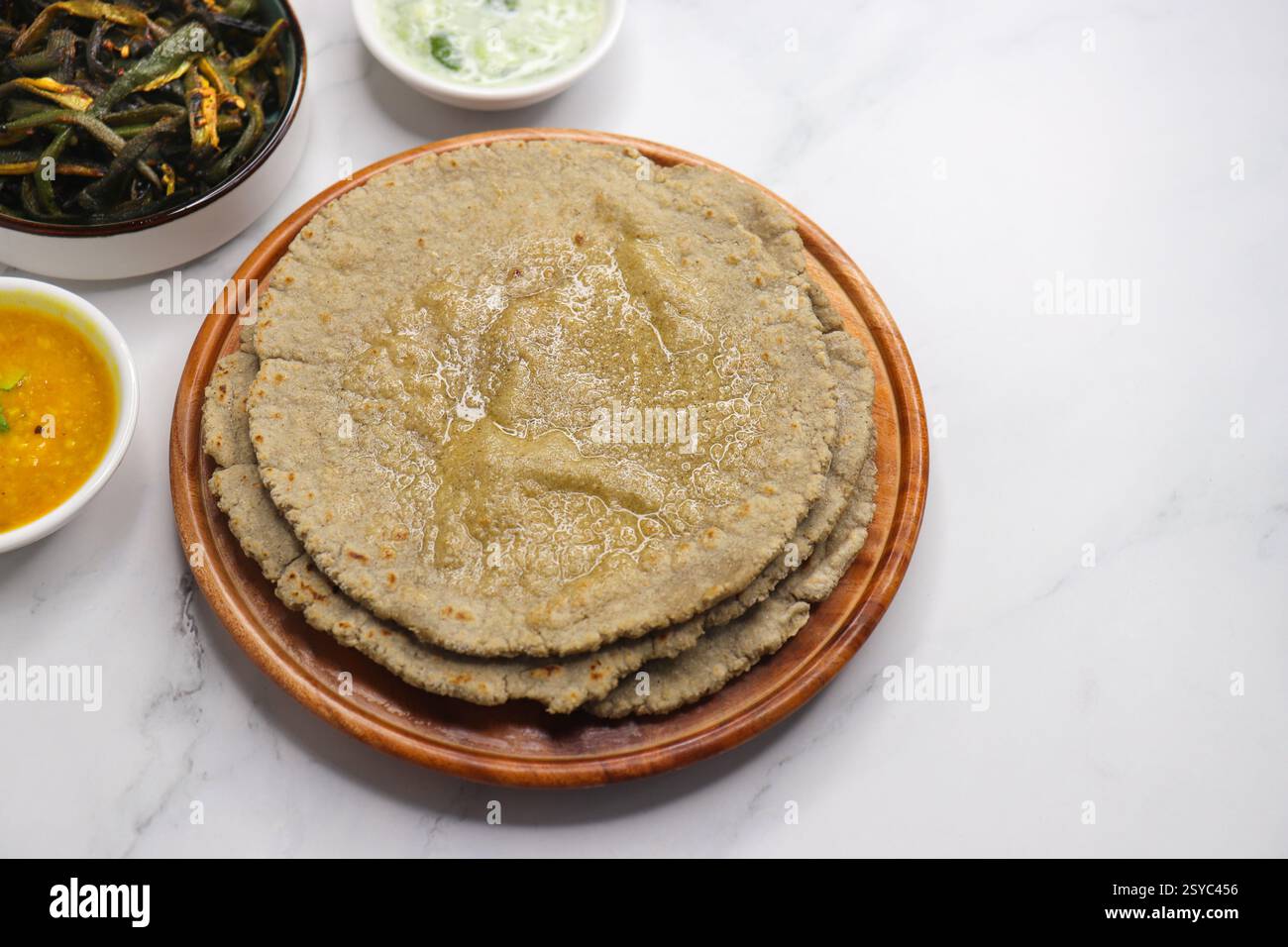 Roti and Sabzi. Indian vegetarian Thali includes bhindi fry, yellow ...