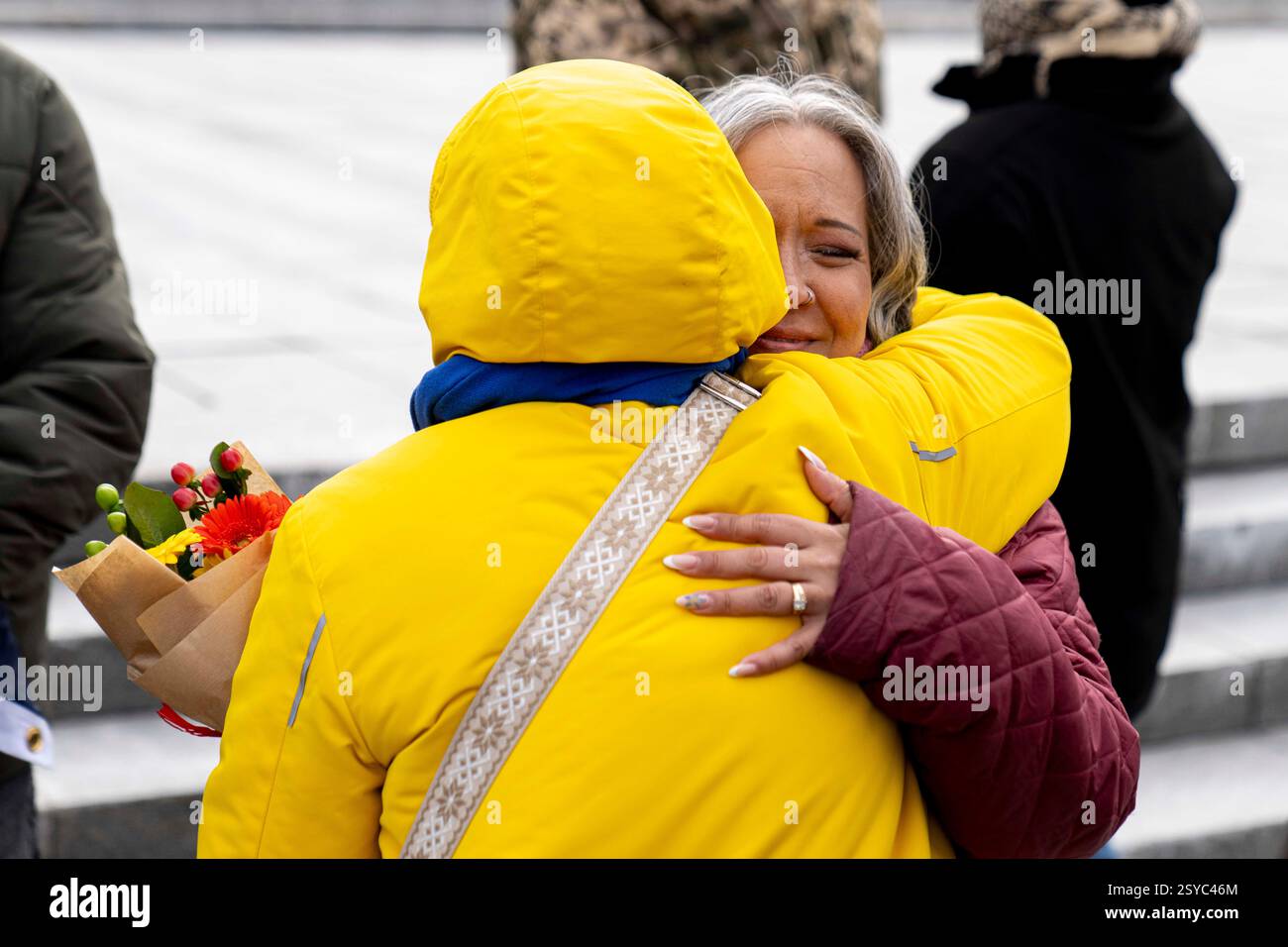 Mother Leslie Hertweck hugging friends of her son at memorial service ...
