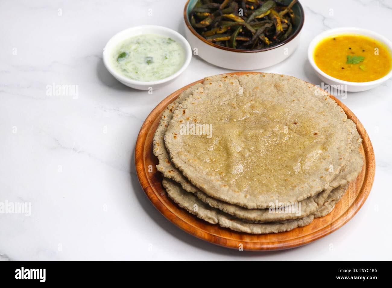 Roti and Sabzi. Indian vegetarian Thali includes bhindi fry, yellow ...