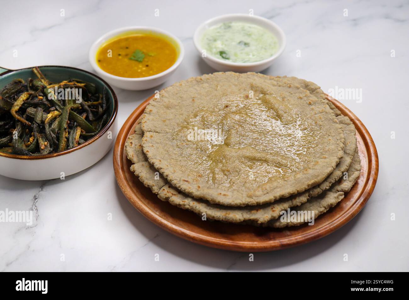 Roti and Sabzi. Indian vegetarian Thali includes bhindi fry, yellow ...
