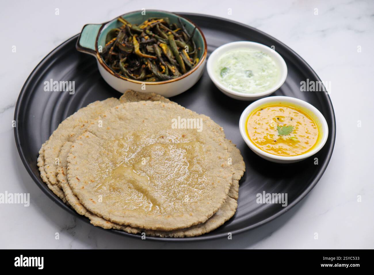 Roti and Sabzi. Indian vegetarian Thali includes bhindi fry, yellow ...
