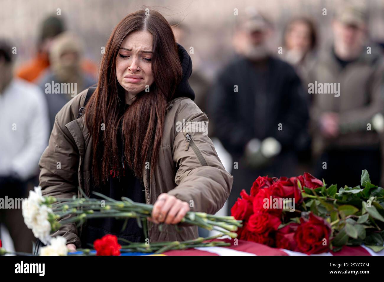 Friends and fellow soldiers lay flowers on coffin at Memorial service ...