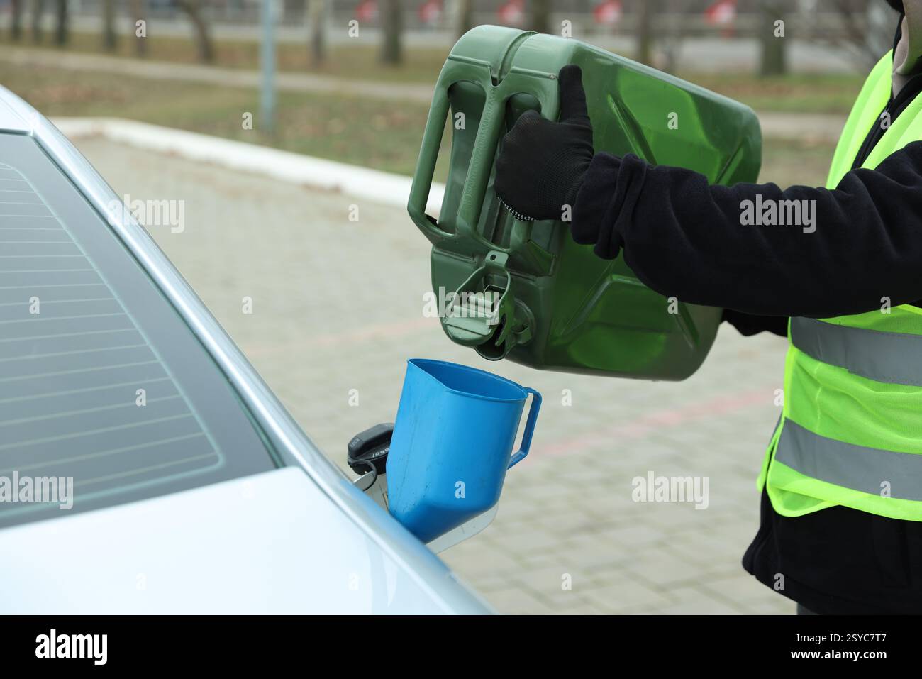 Man pouring fuel from canister into funnel outdoors, closeup Stock ...