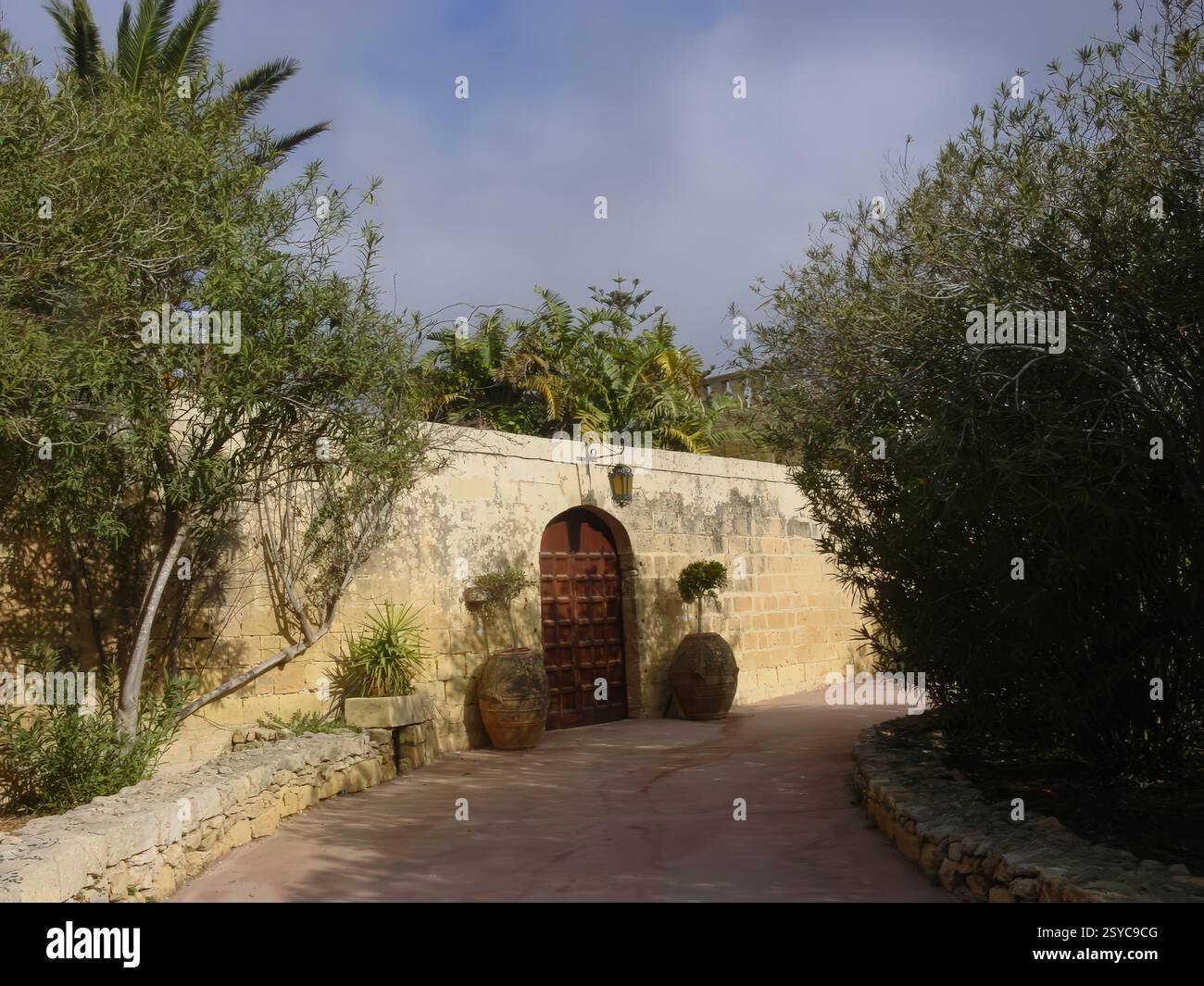 Traditional Stone Wall and Courtyard Path with Wooden Doorway in Garden ...