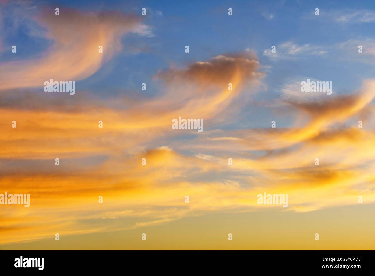 Stunning sunset sky featuring orange, yellow, blue hues, wispy clouds ...