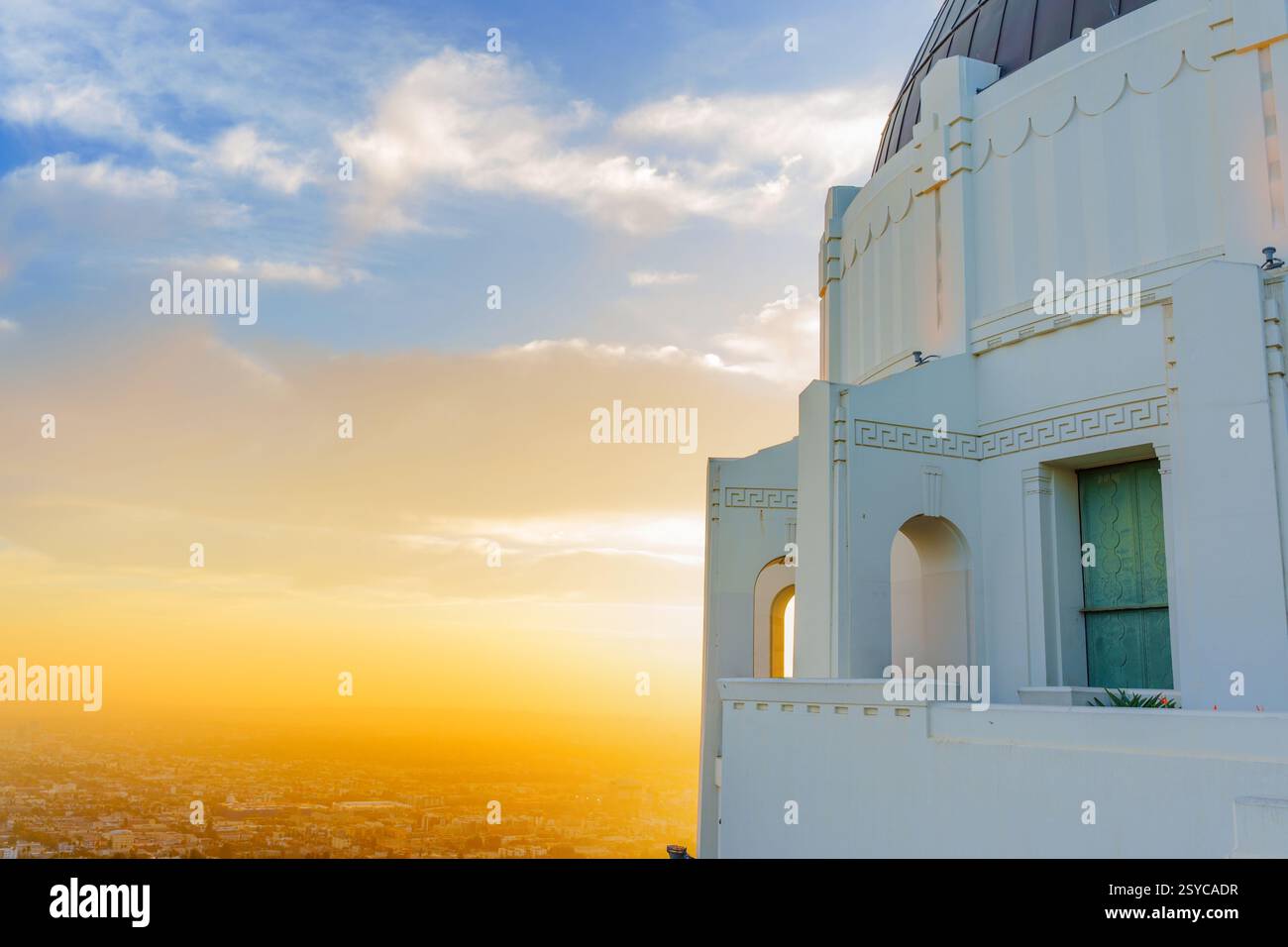 View of Griffith Observatory at sunset with warm colors in sky and ...