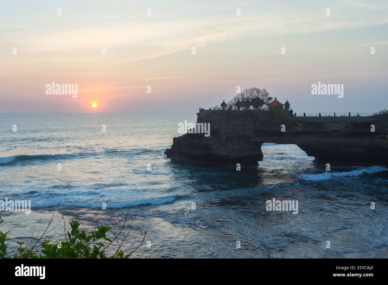 Pura Tanah Lot is a Hindu temple located on a rocky hill, resembling an ...