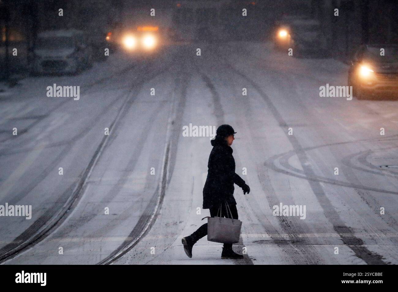 FILE - A commuter braves the wind and snow in frigid weather, Jan. 30 ...