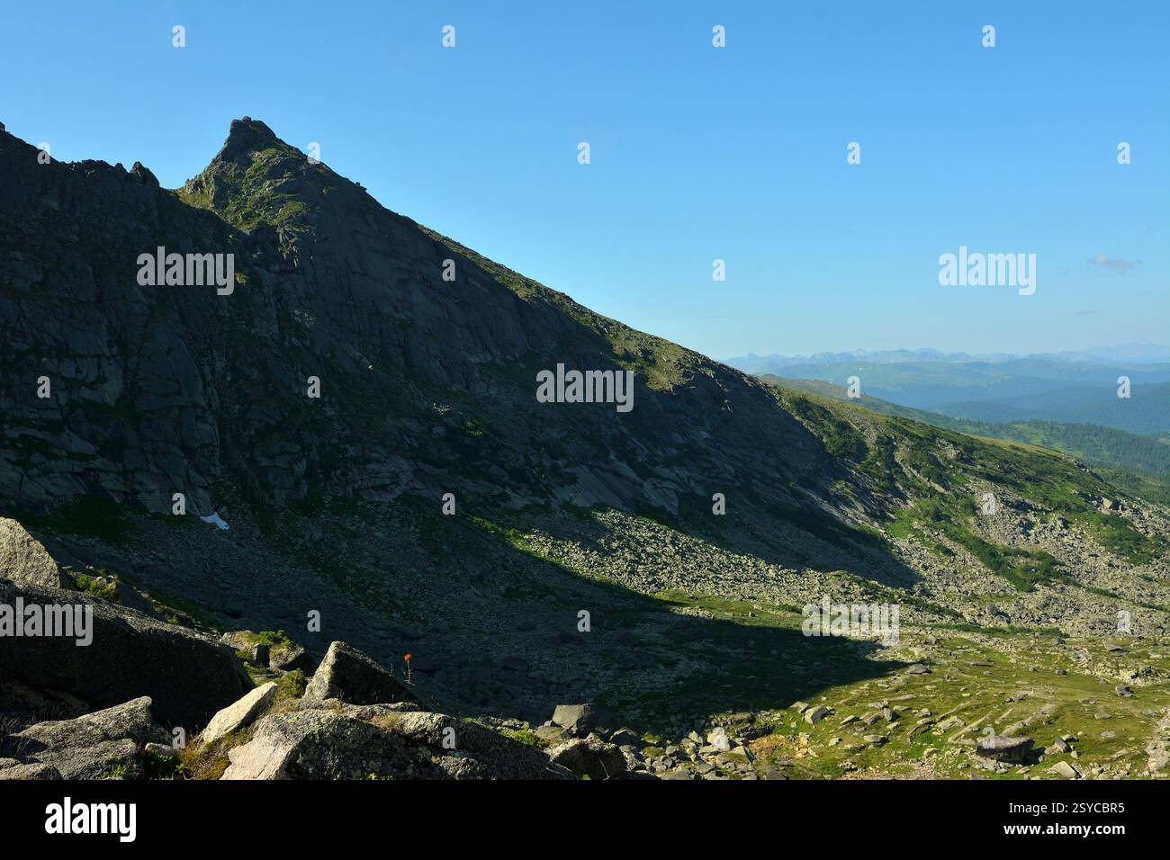 High pointed rocks cast a shadow from the rising sun on a picturesque ...