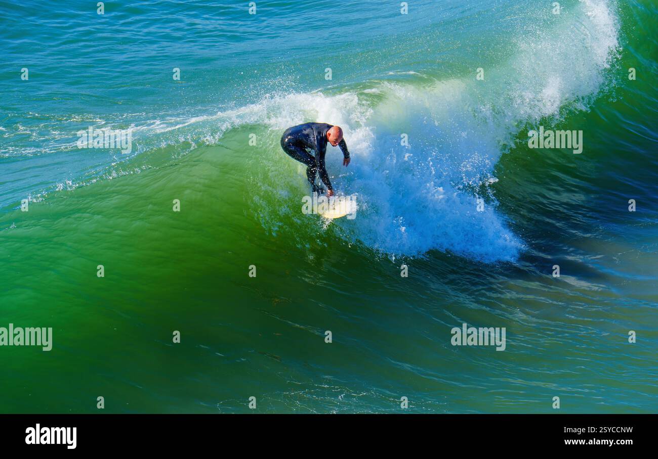 Oceanside, California - December 26, 2024: Surfer carving a wave in the ...