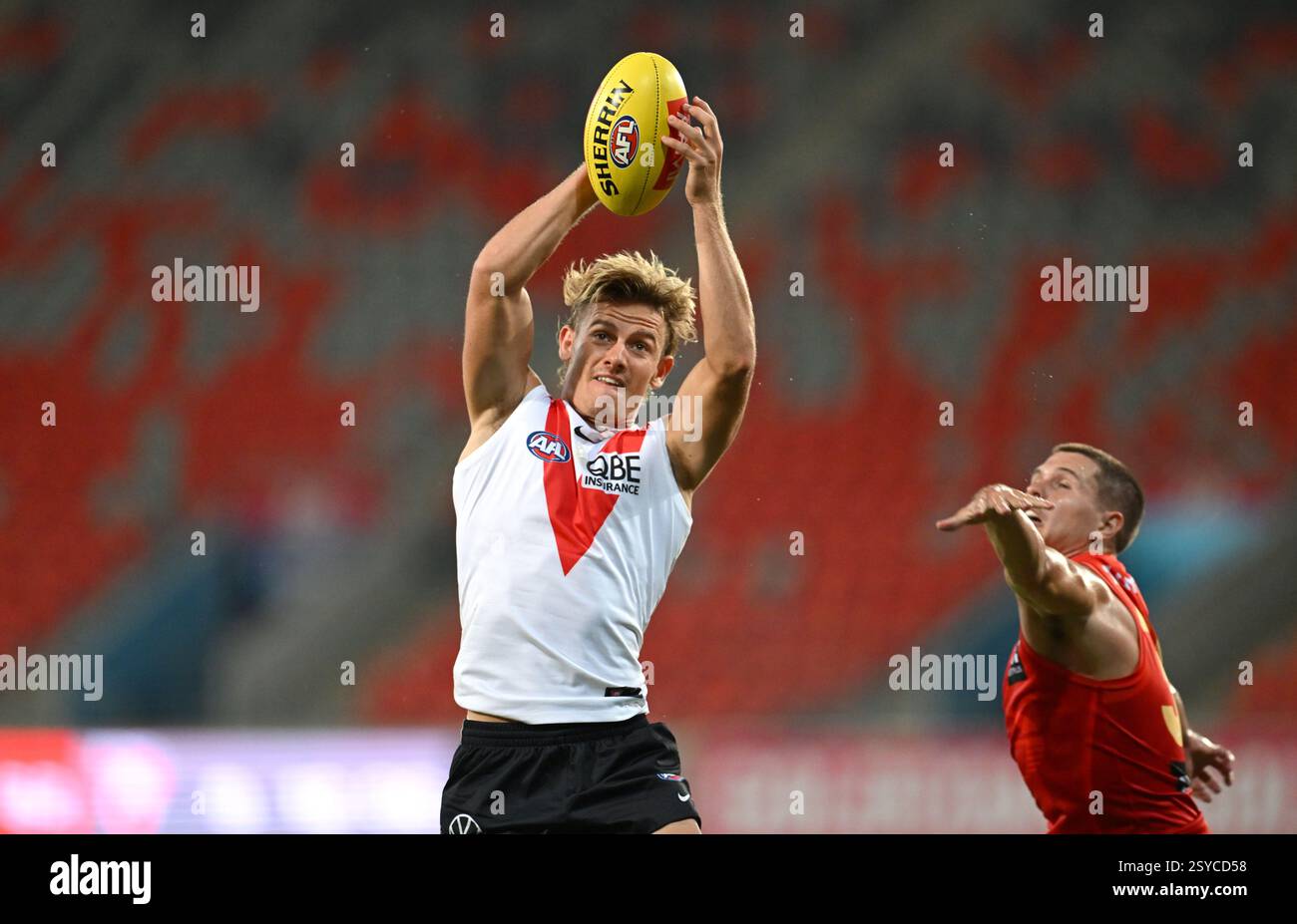 Gold Coast, Australia. 28th Feb, 2025. Corey Warner of the Swans marks ...