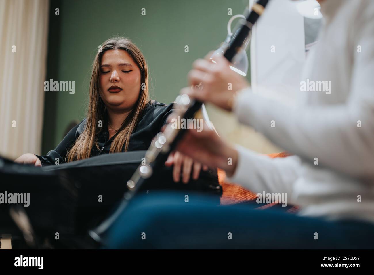 Young musician practicing the clarinet during a music lesson session ...