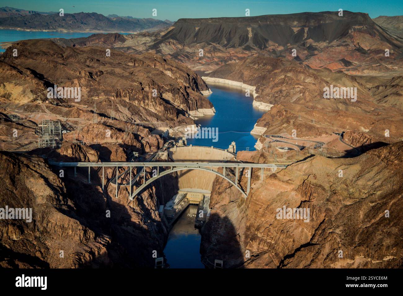 Bridge spans a river in the desert. The bridge is over a large body of ...