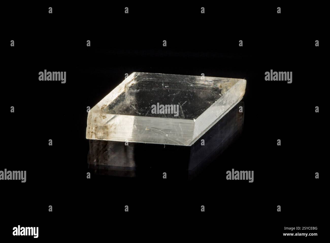 Clear glass object is on a black background. It is rectangular in shape ...