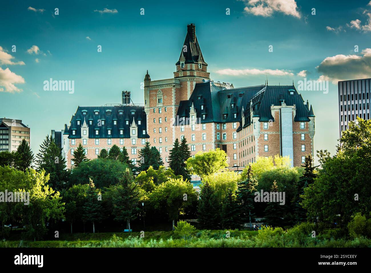 Large brick building with a steeple and a clock tower. The building is ...