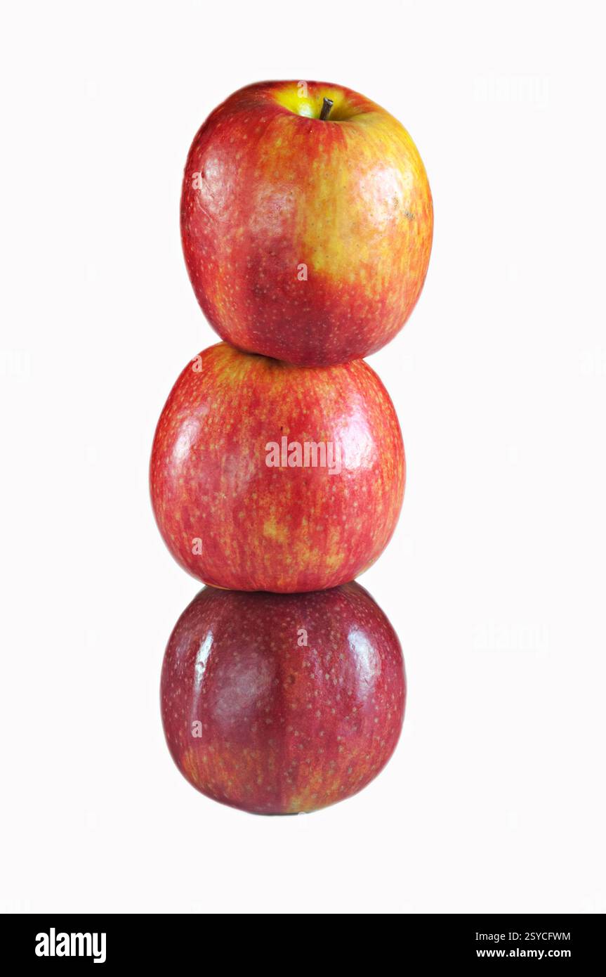 Three red apples, one on top of the other, of the Pink Lady variety ...