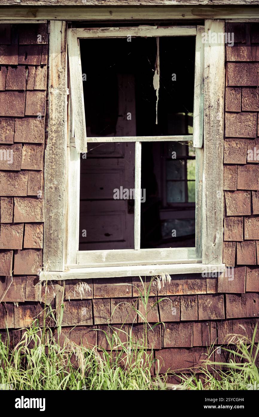 Window is open in a house with a wooden frame. The window is dirty and ...