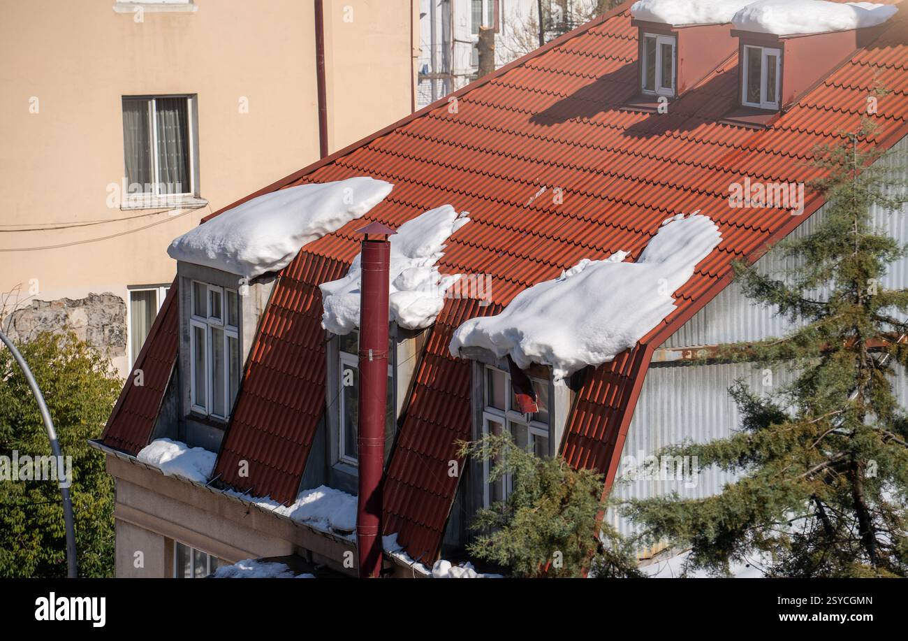 Heavy snow on rooftops in Batumi melting under the sun, creating ...