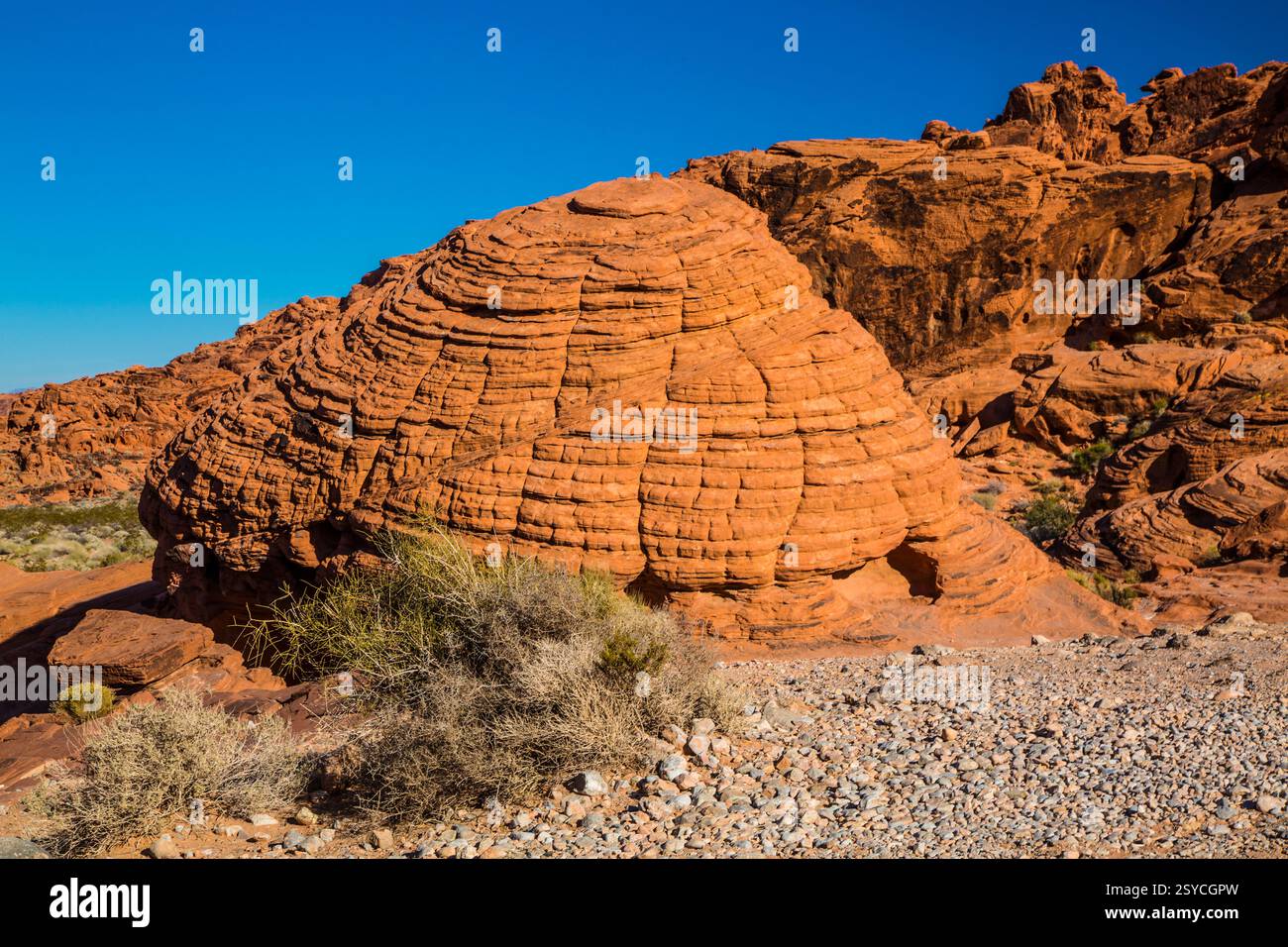 Large rock with a lot of cracks and crevices. The rock is brown and is ...