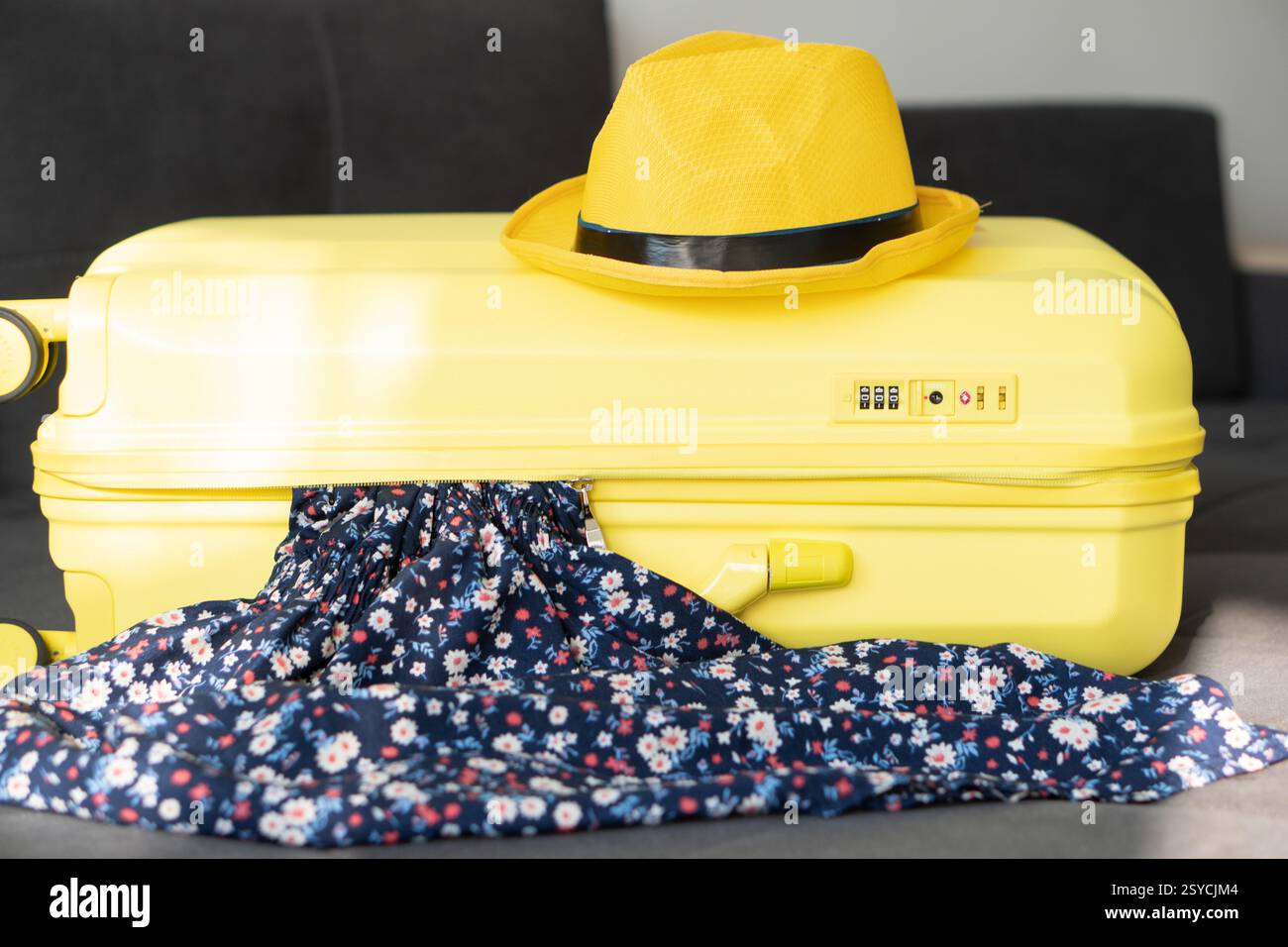 Bright Yellow Suitcase Overstuffed with Clothes and Travel Hat Stock ...