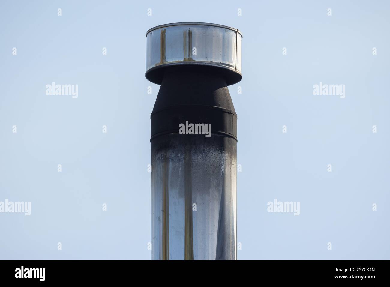 Сlose-up view of a cylindrical shiny metal chimney pipe with a ...