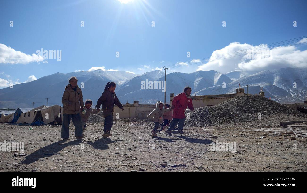Lhasa. 23rd Feb, 2025. Children play at a resettlement site in Dingri ...