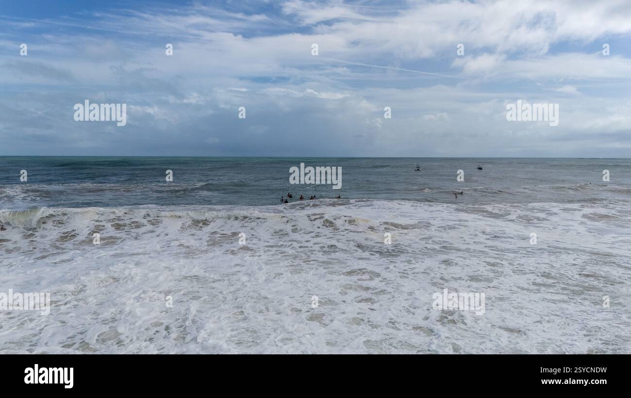 Aerial Drone Shot Looking down on a group of surfers in the caribbean ...