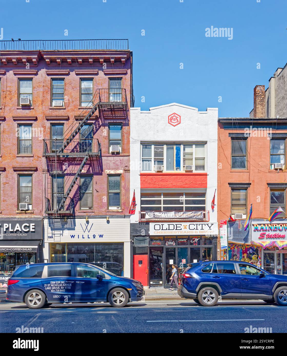 A low rise commercial building (201, center) next to a run-down brick ...