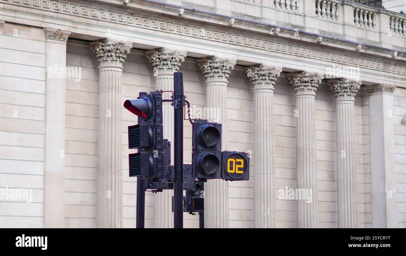 Traffic lights on a European street with pedestrians and tall glass ...