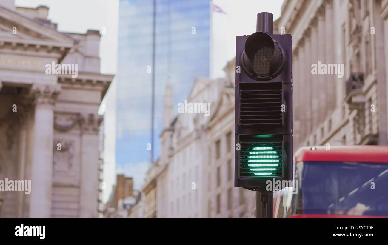 Traffic lights on a European street with pedestrians and tall glass ...