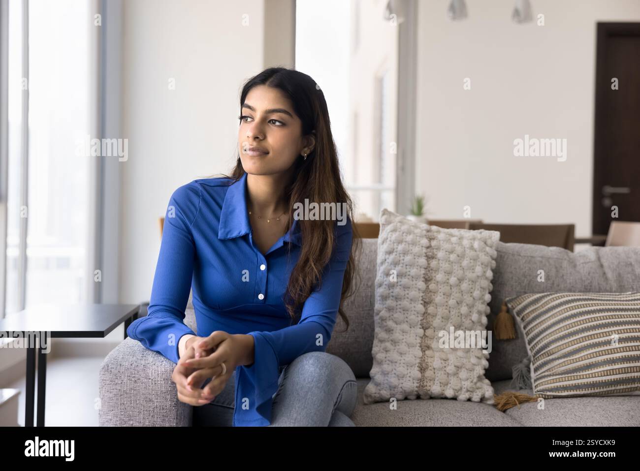 Young Indian woman gaze thoughtfully out of window Stock Photo - Alamy