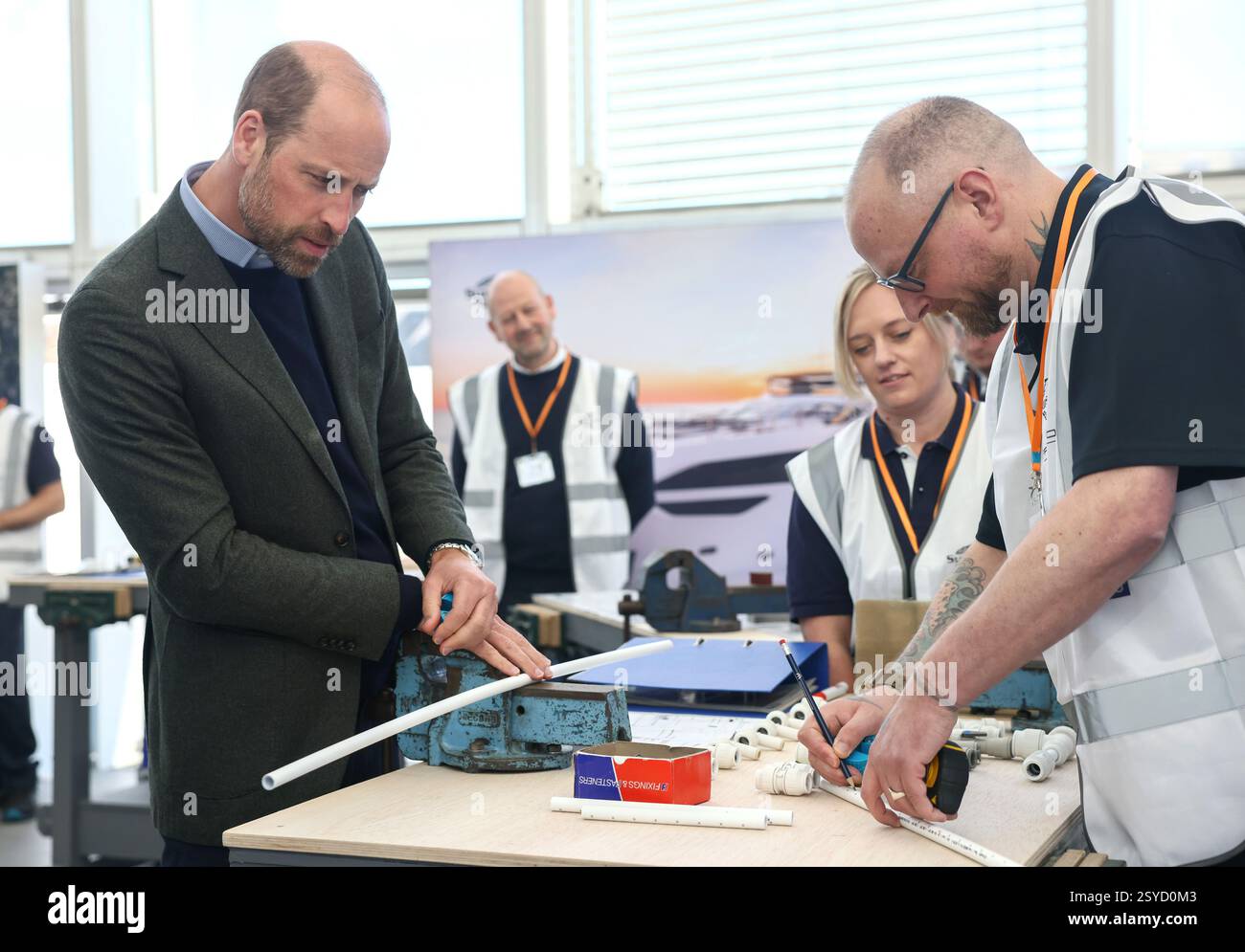 The Prince of Wales is shown boat building techniques by Trainee Boat ...