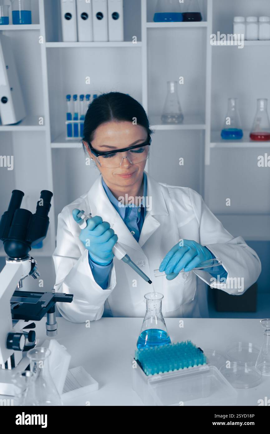 A scientist conducts a lab experiment using a micropipette and ...