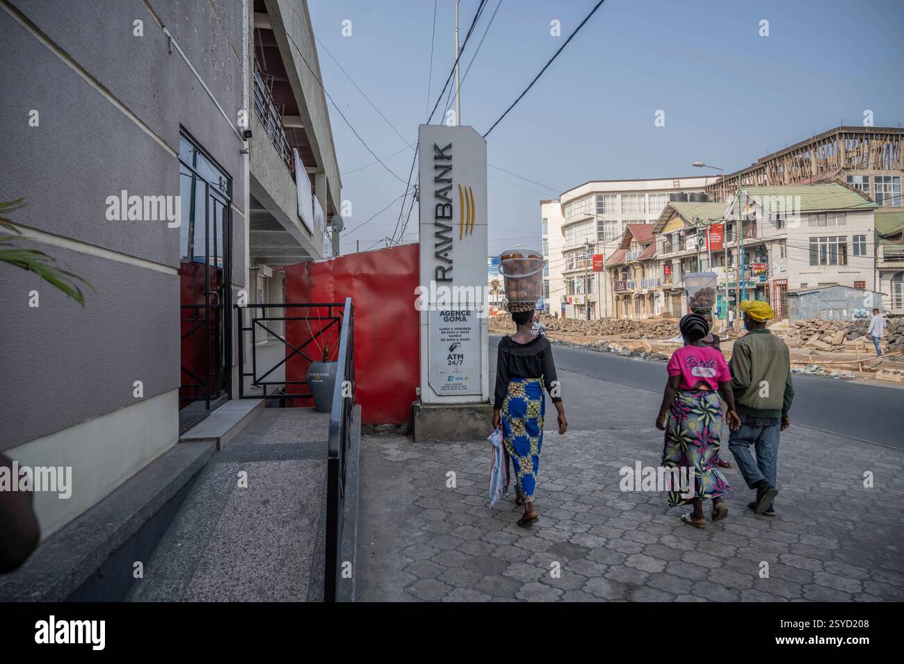 People walk past a closed bank in downtown Goma, Democratic Republic of ...