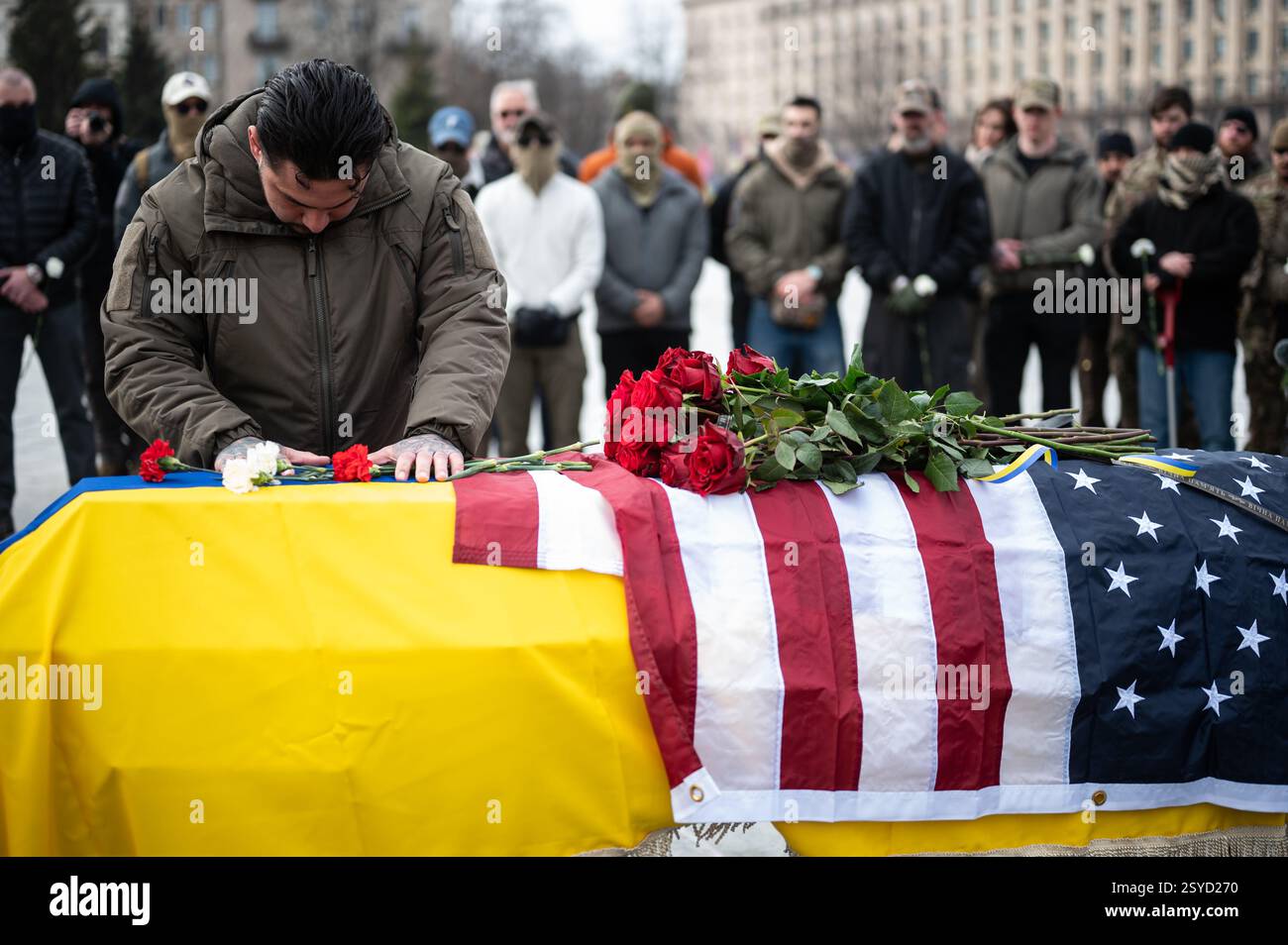 A man stands at the coffin of Ethan Hertweck, a 21-year-old U.S. Marine ...
