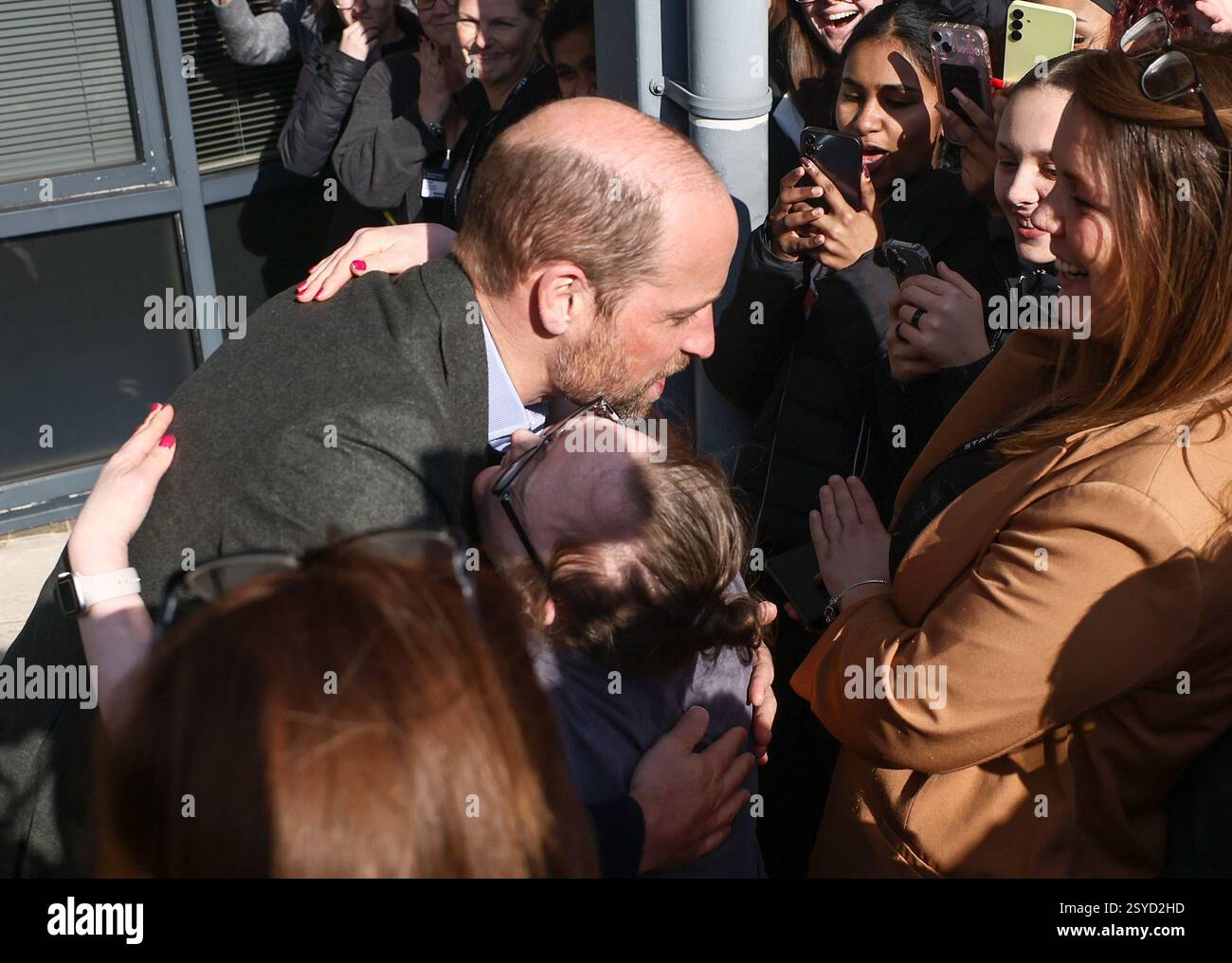 The Prince of Wales hugs well-wisher Natasha Gorry during his visit to ...