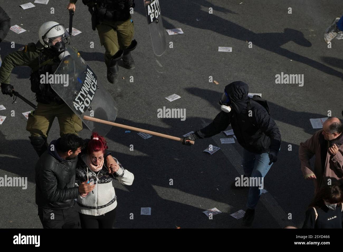 A hooded protester clashes with a riot policeman after a massive rally ...