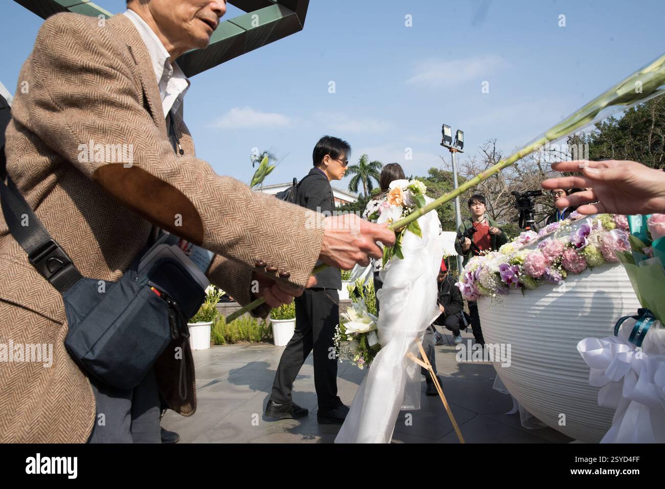 Descendants of the victims of the 228 Massacre lay floral tributes in ...