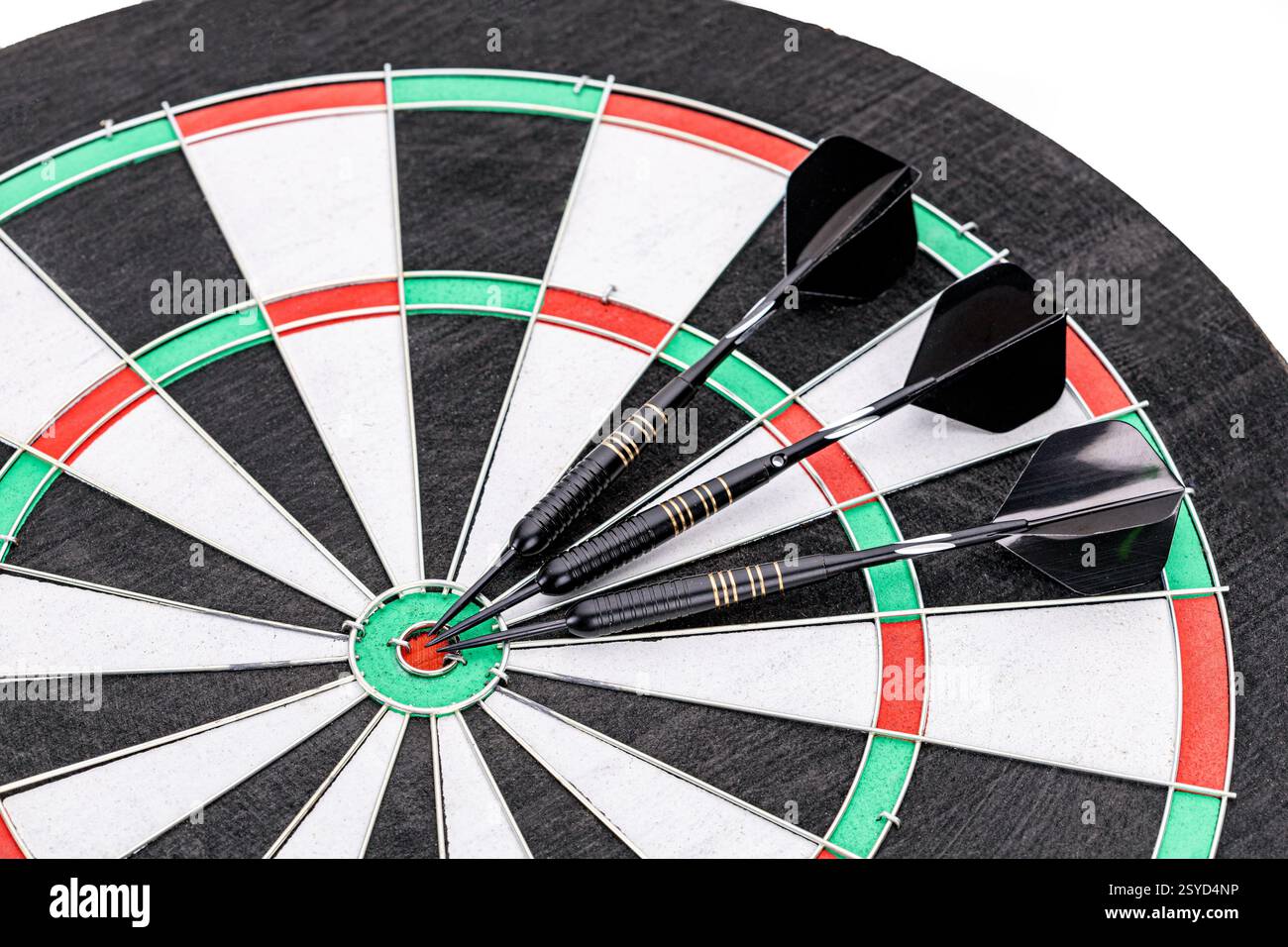 Three black darts are placed on a dartboard Pointing towards the center ...
