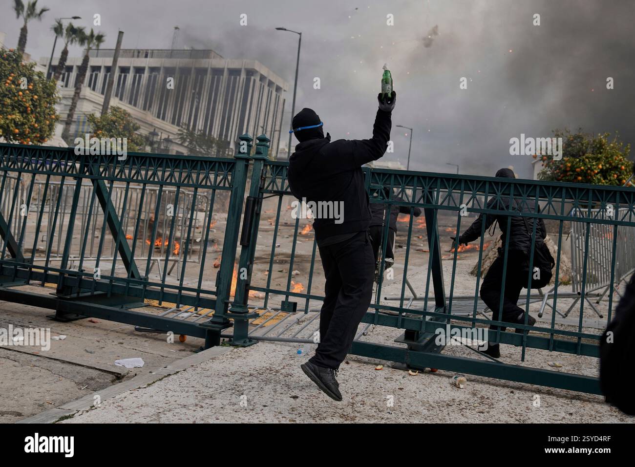 A protestor throws a molotov cocktail against the riots police outside ...