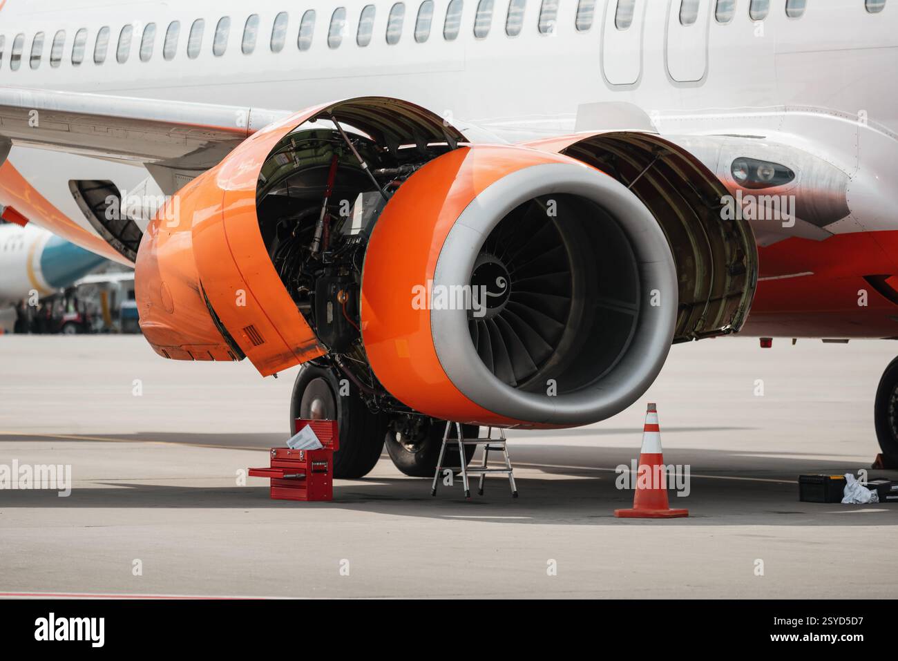 Aircraft jet engine maintenance. Opened cowling of passenger airplane ...