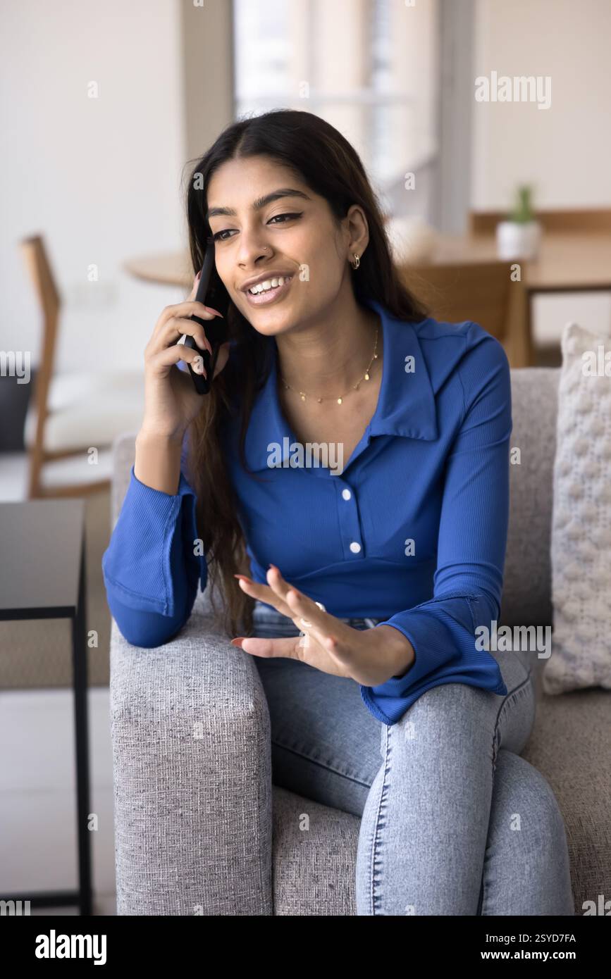 Self-assured Indian woman lead personal call seated on sofa Stock Photo ...