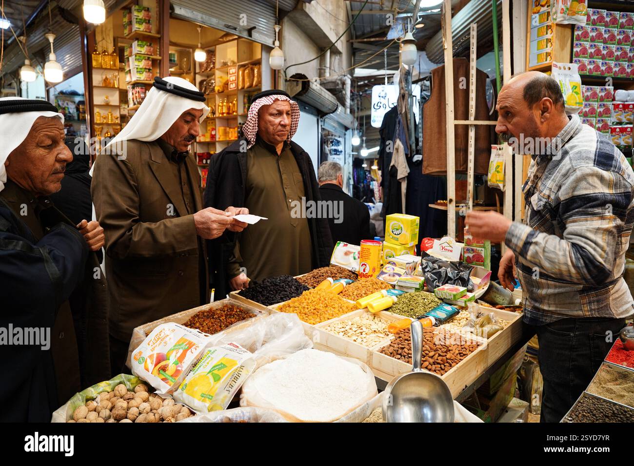 Mosul, Iraq. 27th Feb, 2025. Customers buy spices from a seller at the ...