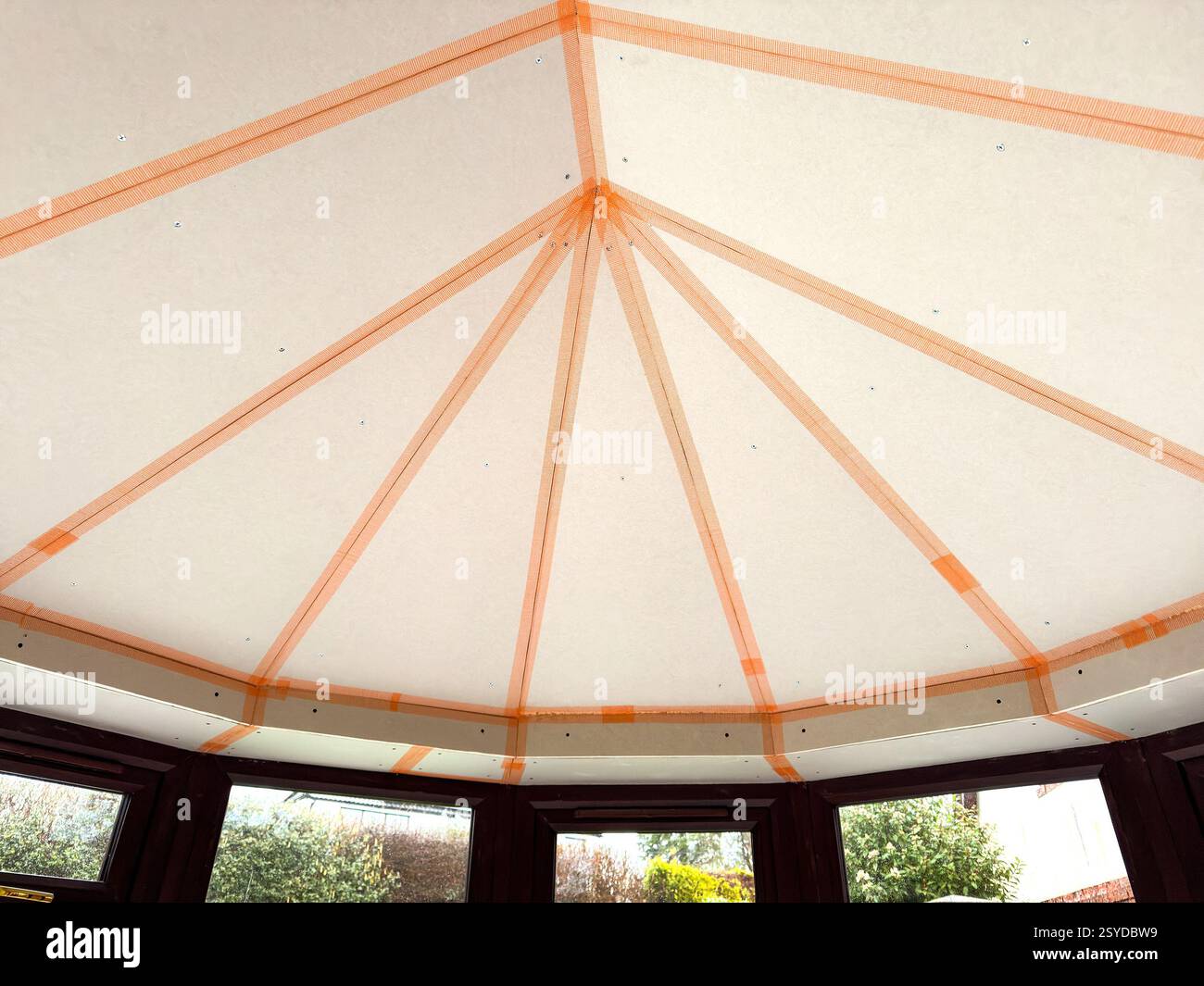 Tape on the joints of plasterboards on the ceiling of a new ...