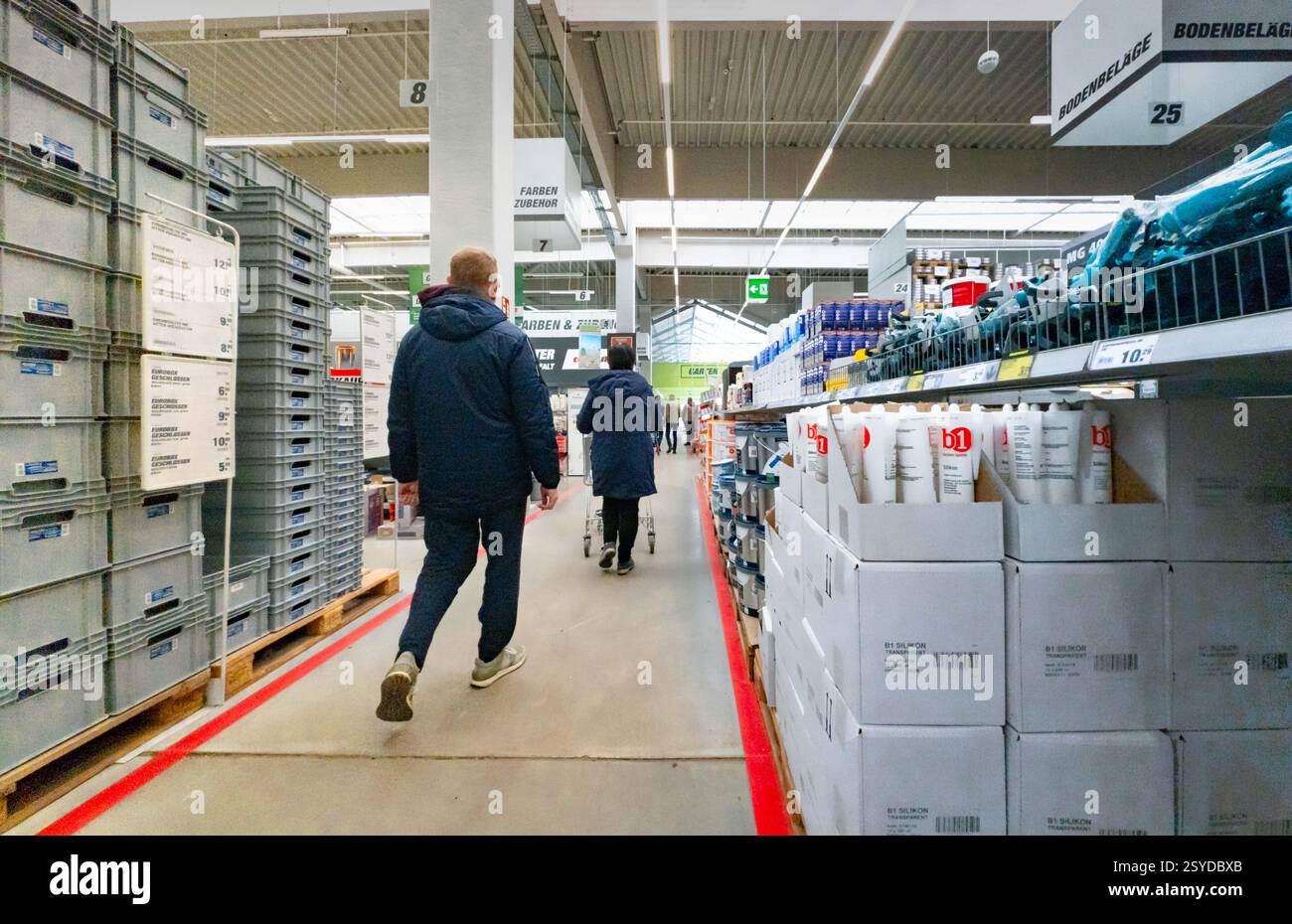 22 February 2025, Hamburg: Customers walk through a DIY store. Photo ...