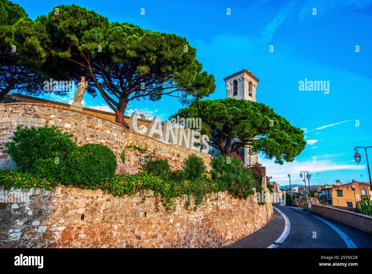 Awe sunrise light on garden and Sign of Cannes next to World ...