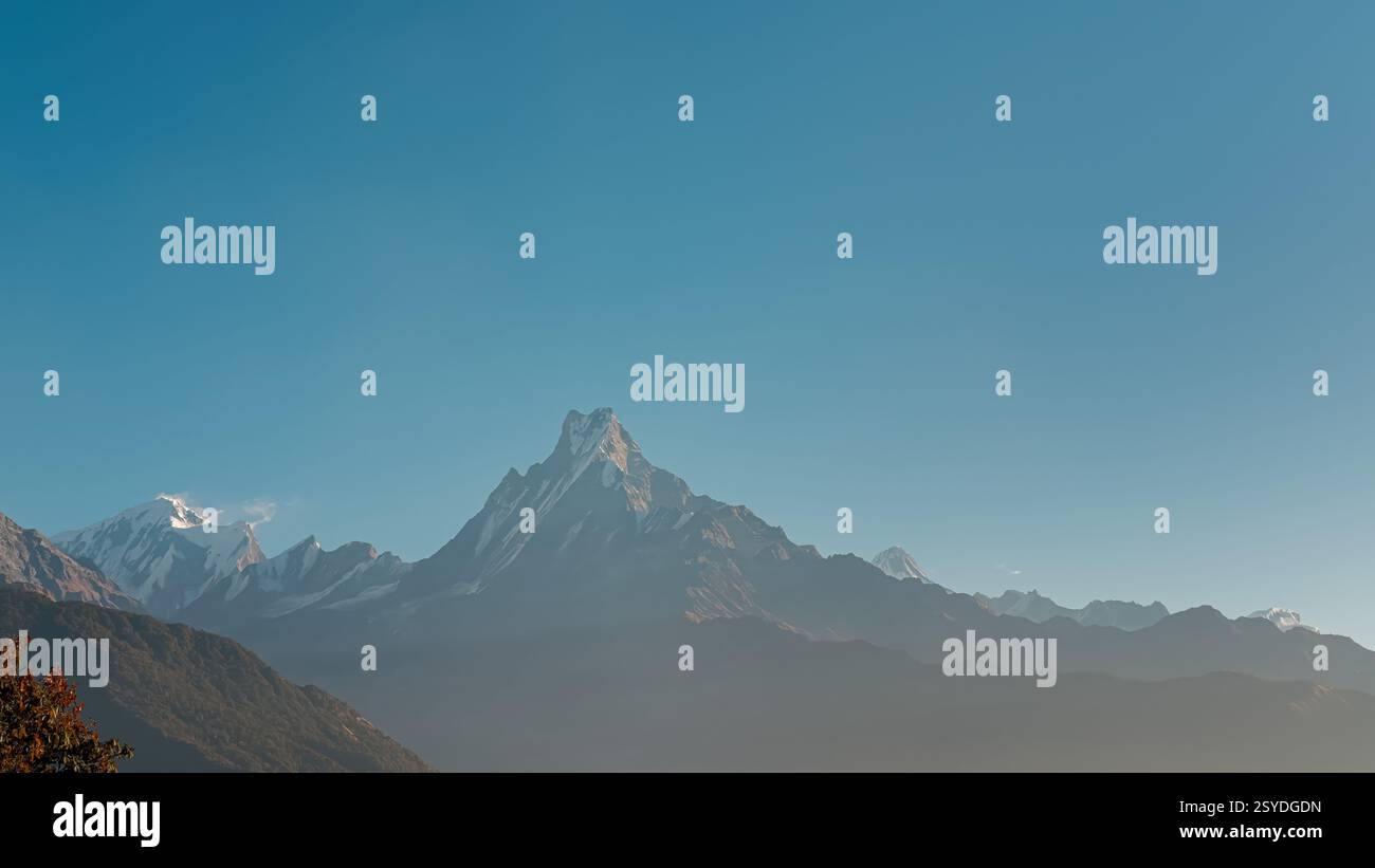 Morning sunlight highlights the majestic peaks of Annapurna range ...