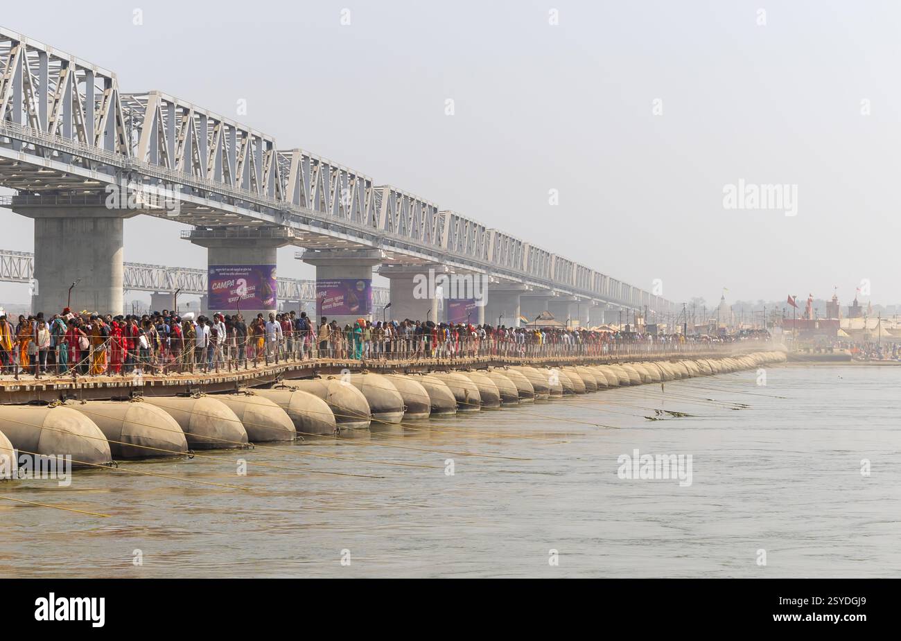 crowded people crossing pontoon bridge over ganges river at triveni ...