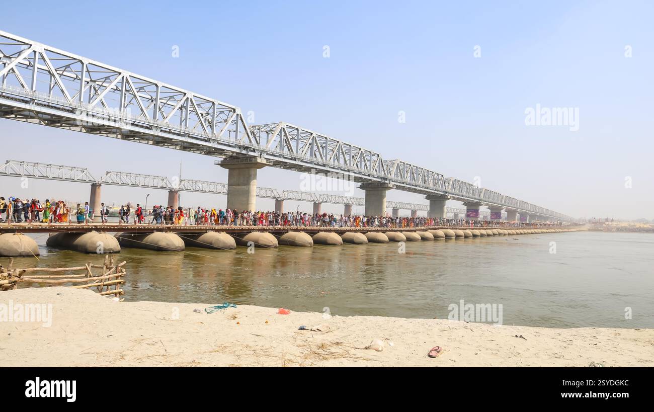 crowded people crossing pontoon bridge over ganges river at triveni ...