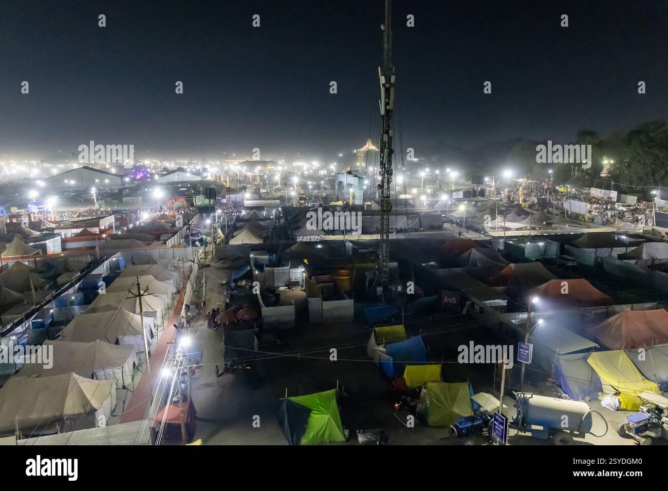 crowded temporary tent shelters lit with floodlights at mahakumbh ...